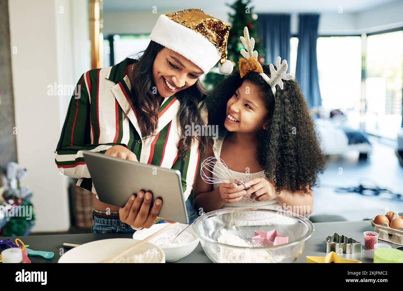 Family, baking and tablet for christmas cookies, cooking or cake with ...