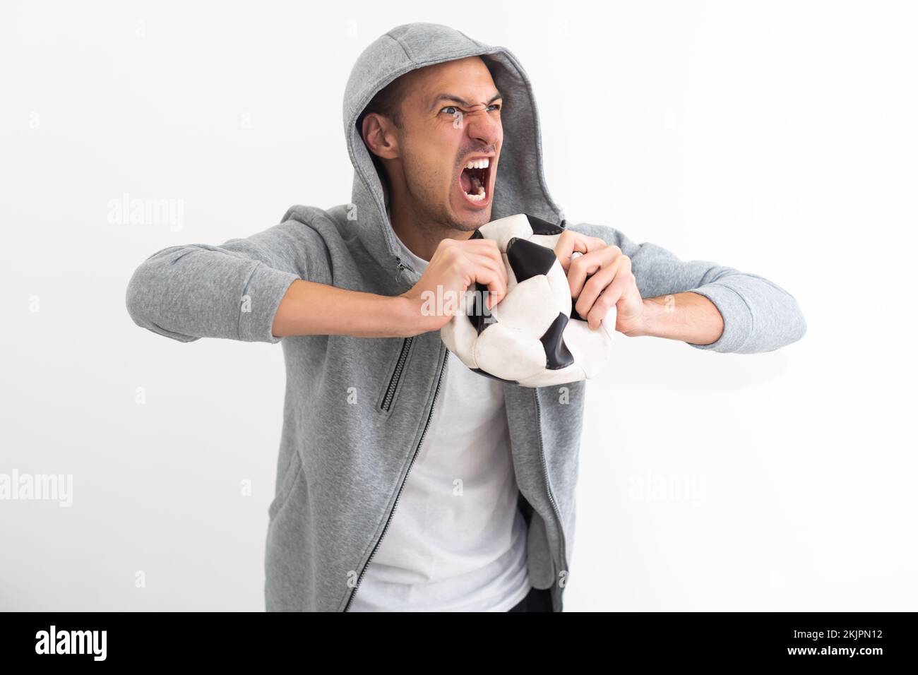 Handsome player man playing soccer holding footballl ball over ...