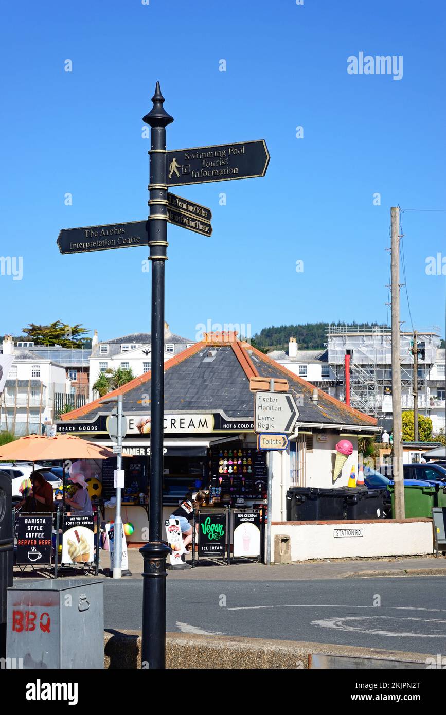 Tourist information signpost with an ice cream parlour to the rear ...