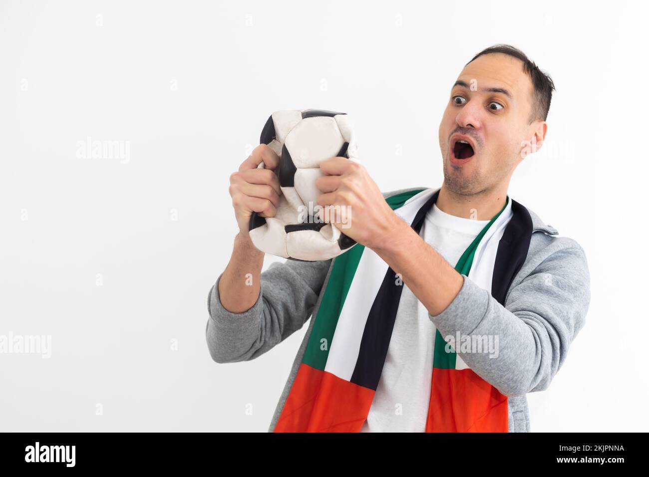 Handsome american man playing footbal holding soccer ball over white ...