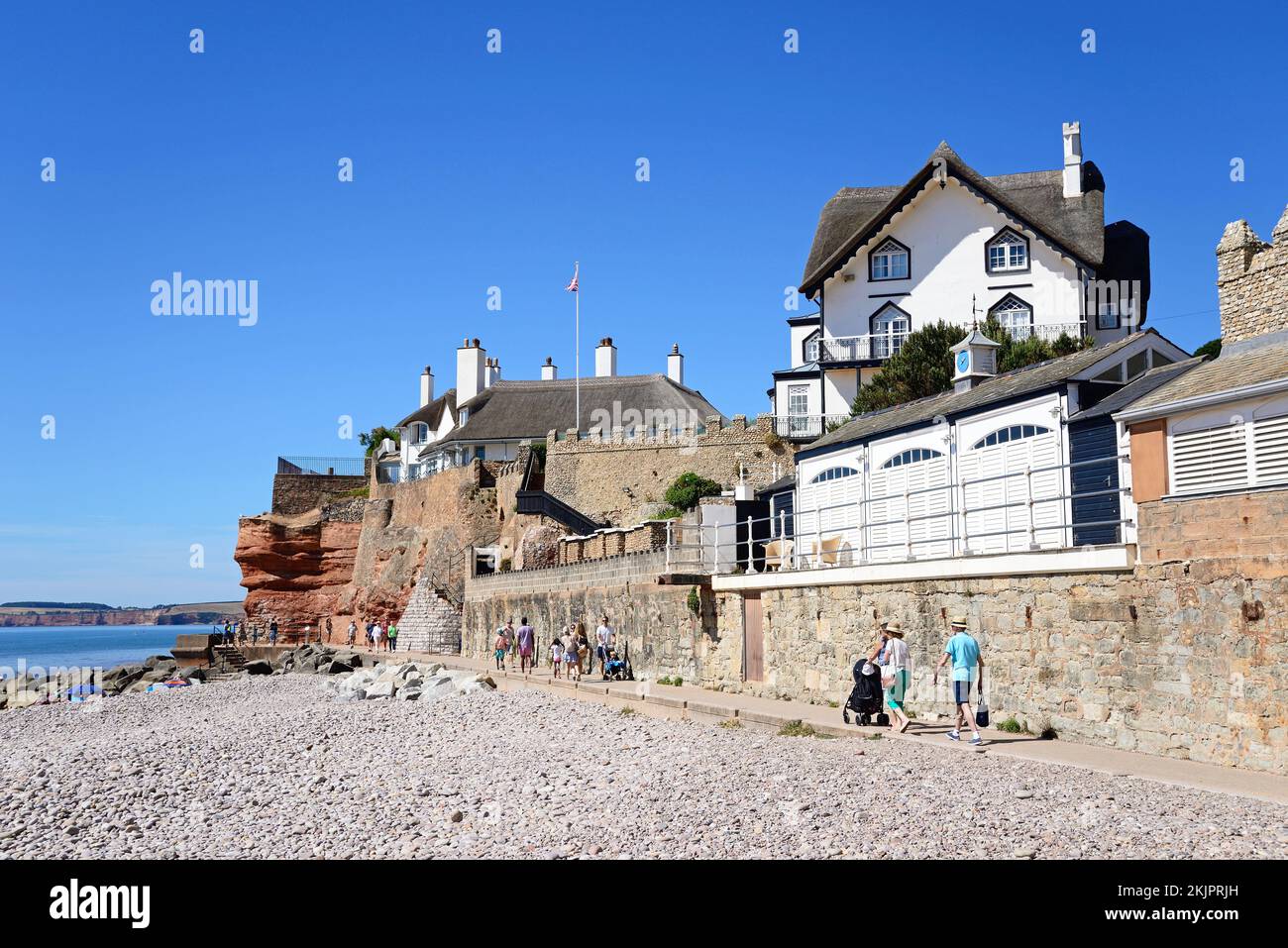 View of traditional thatched houses overlooking the beach and coastline ...