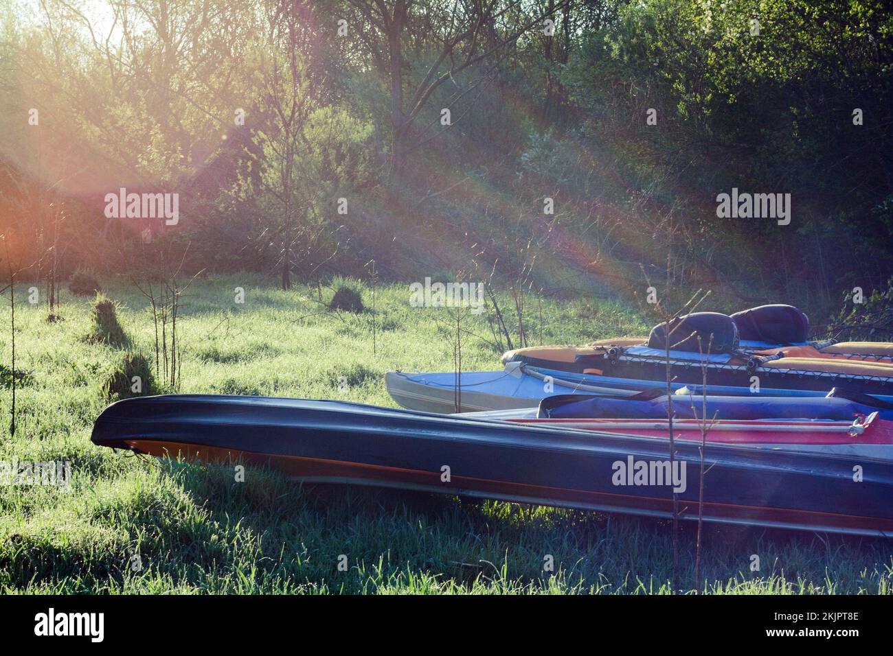 Kayaks drying on grass landscape photo Stock Photo - Alamy