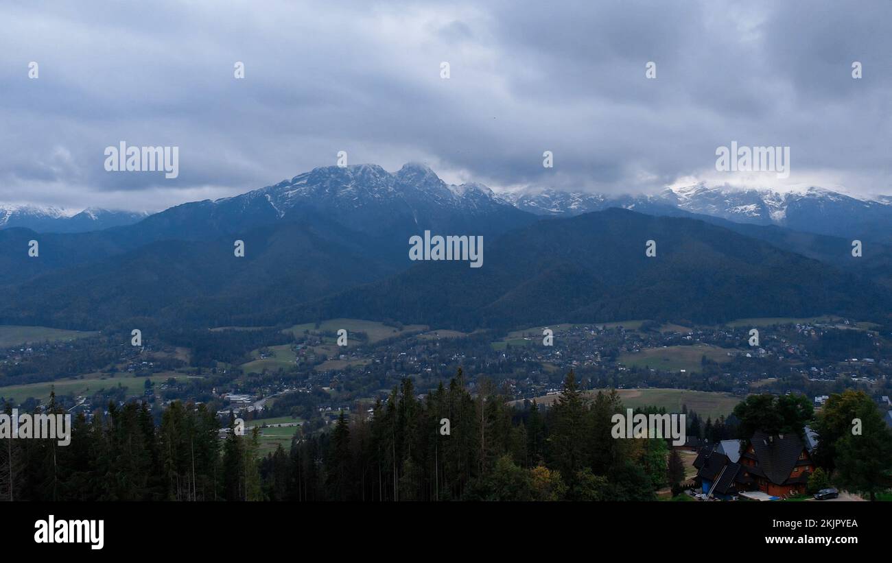 Aerial view of Zakopane town underneath Tatra Mountains taken from the ...
