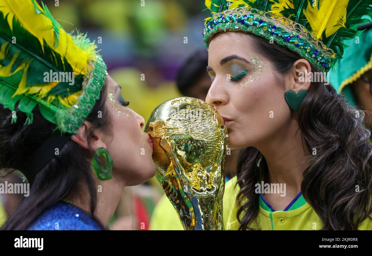 Brazilian supporters, two women wearing yellow and green feathers on ...