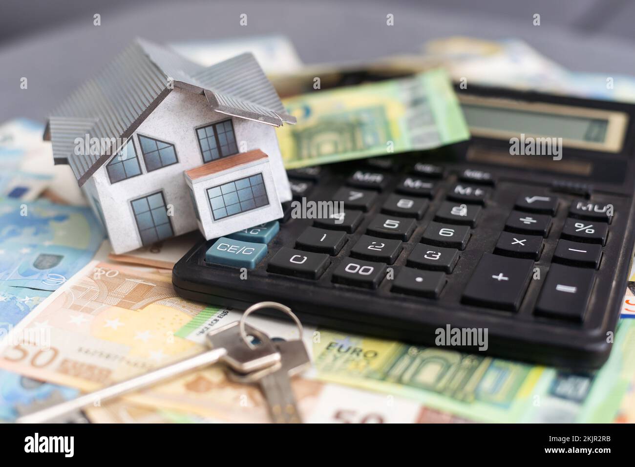 Model house, calculator, euro notes Stock Photo - Alamy