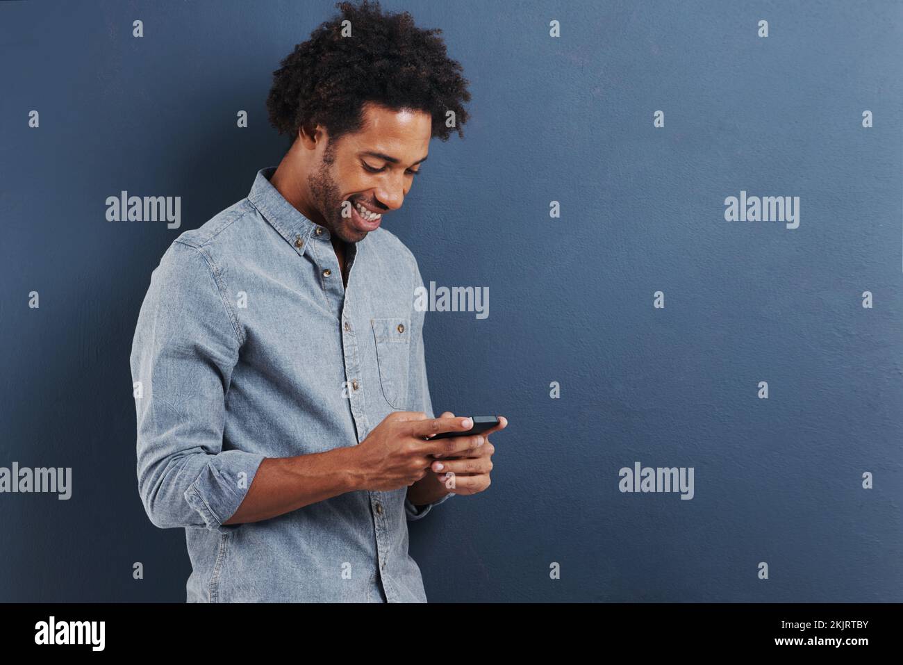 Connected to his circle of friends. a handsome young man using a mobile ...
