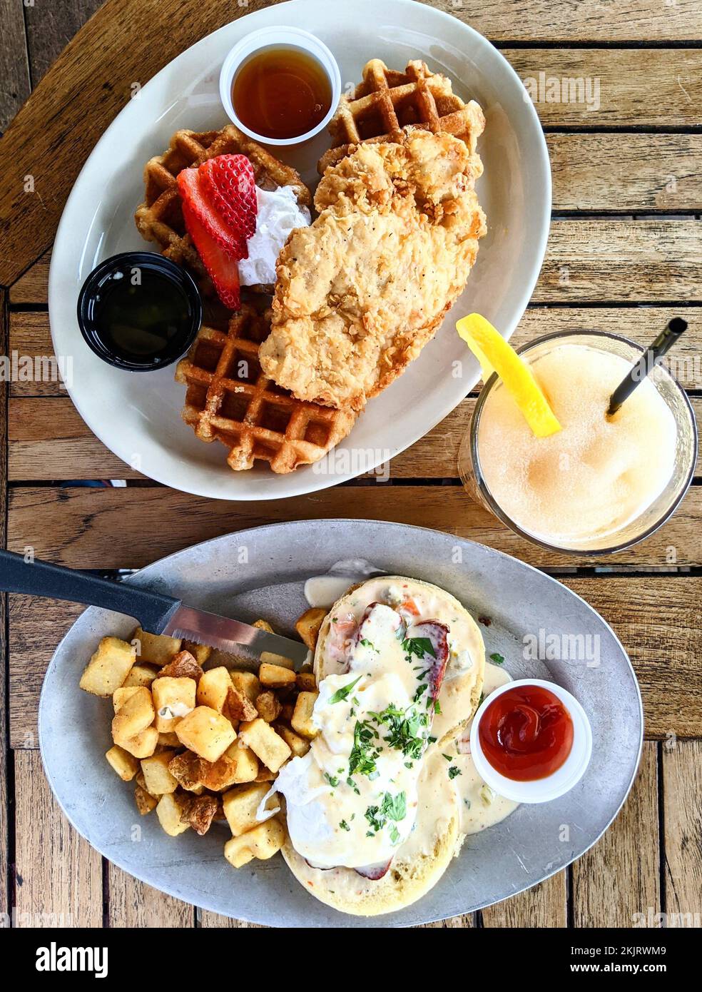 A top view of brunch meal with chicken and waffles and eggs benedict ...