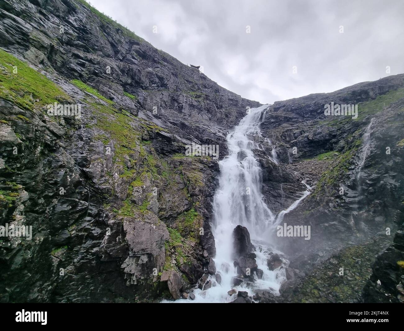 The rocky mountains covered with a huge waterfall, trollstigen, norway ...