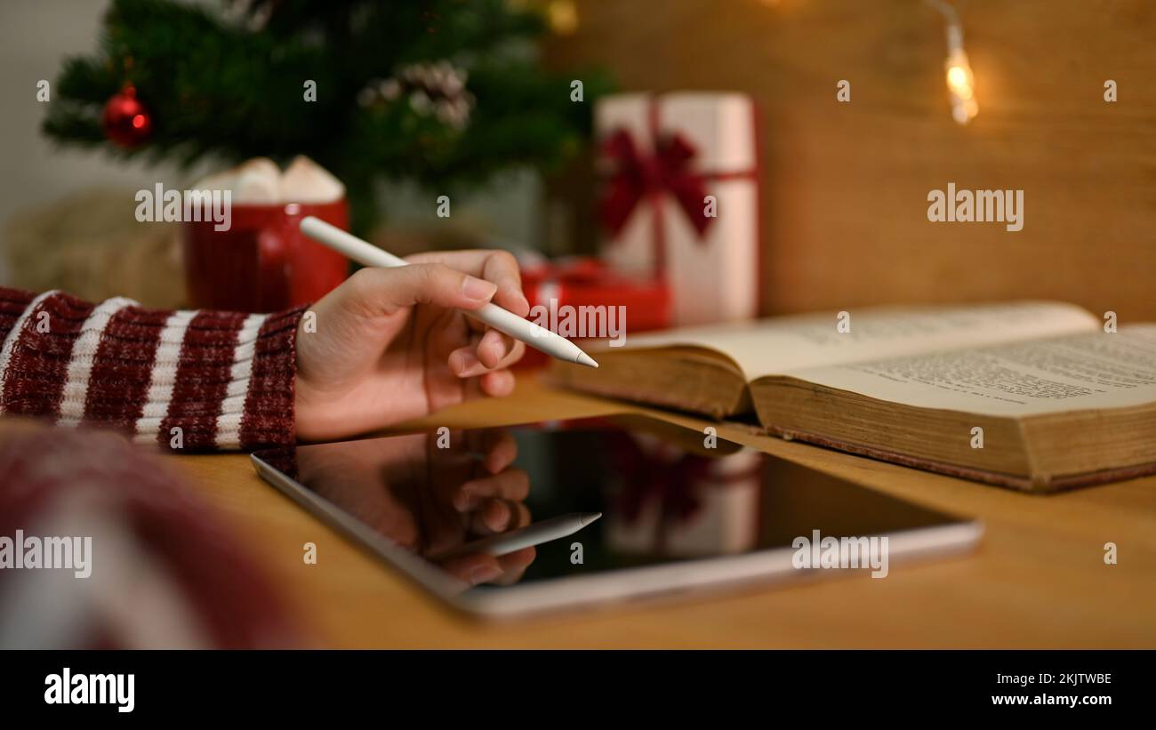 close-up image, A female in cozy sweater using her digital tablet ...