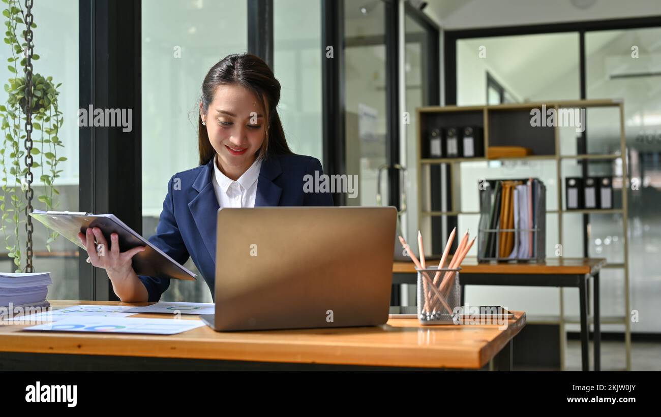 Attractive millennial Asian businesswoman or female manager managing ...