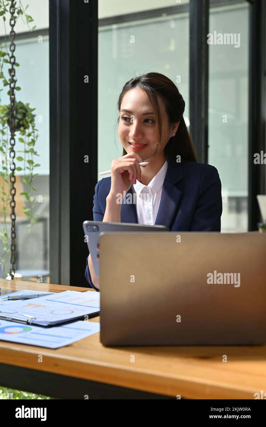Portrait, Successful and charming millennial asian businesswoman or female manager hand on chin ...