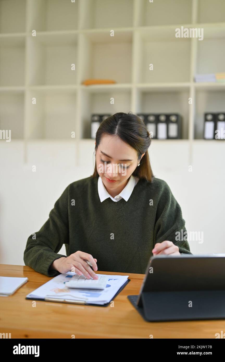 Portrait, Professional Asian female accountant or businesswoman using ...