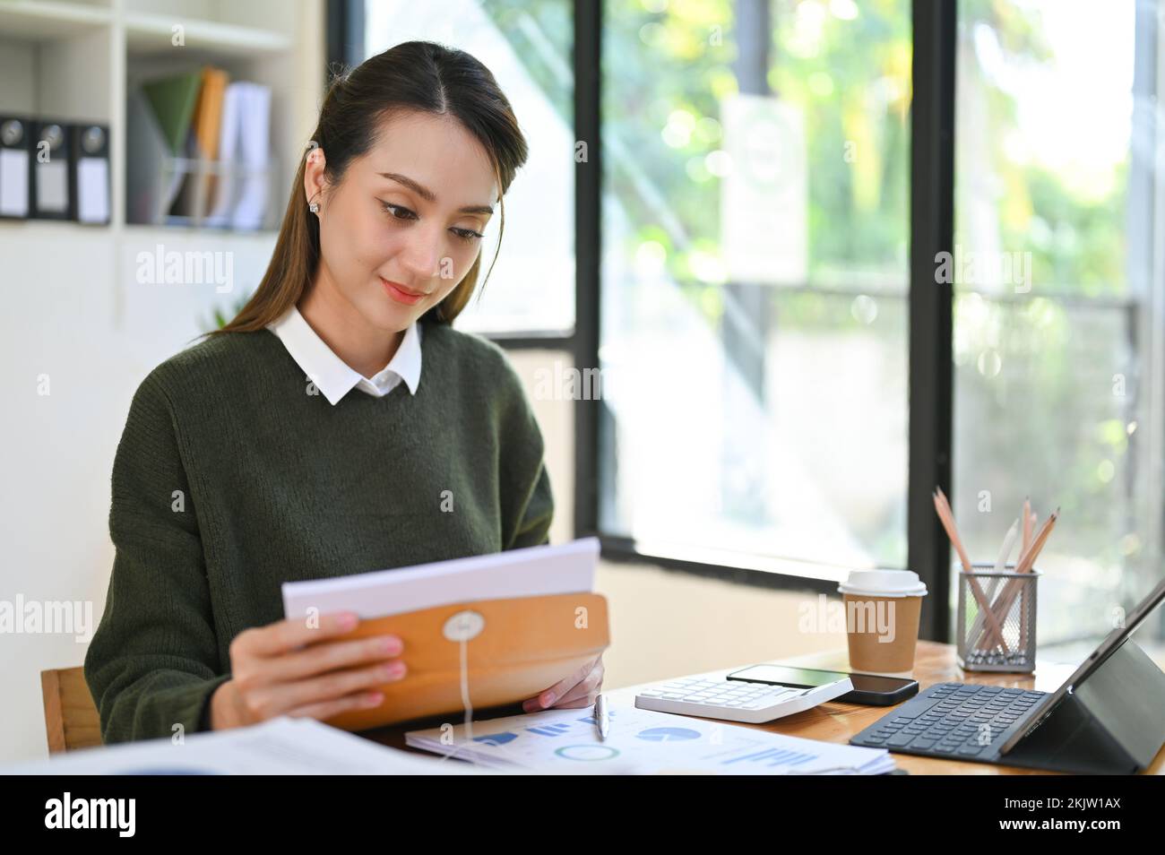 Beautiful millennial Asian businesswoman or female assistant opening ...