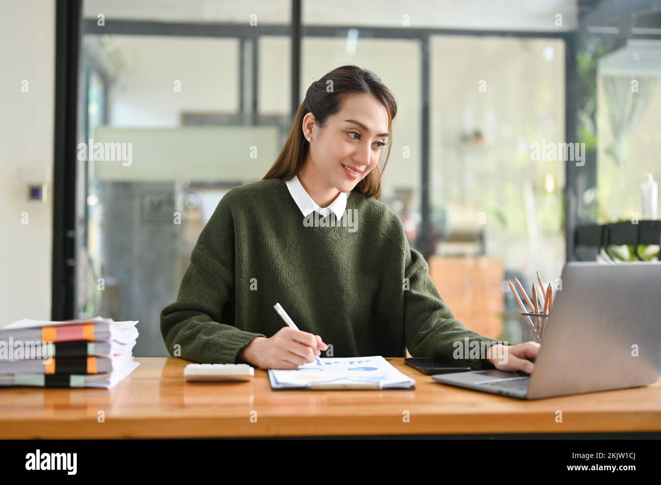Beautiful and happy young Asian businesswoman or female accountant ...