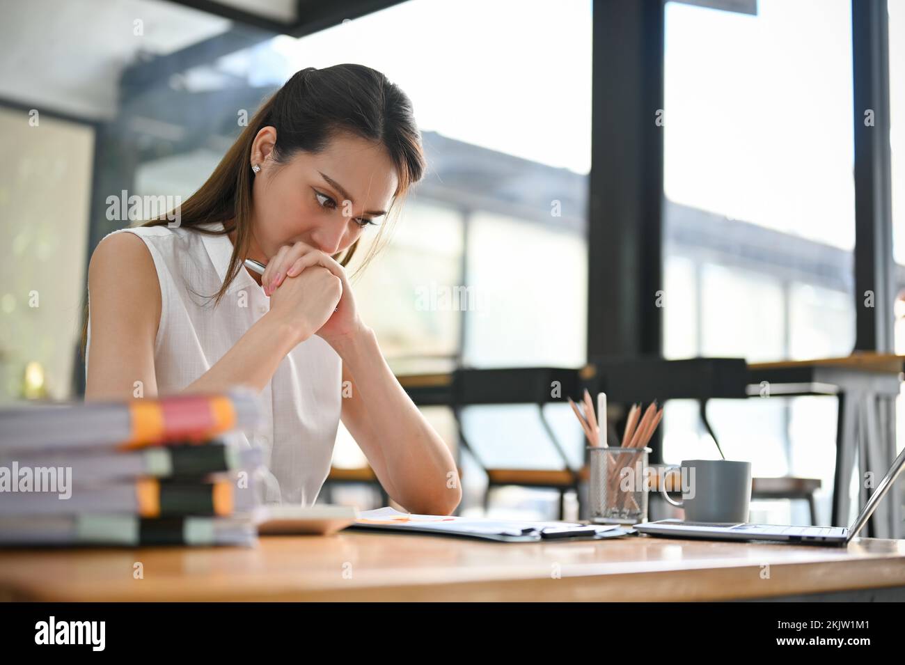 Stressed millennial Asian businesswoman or female project manager ...