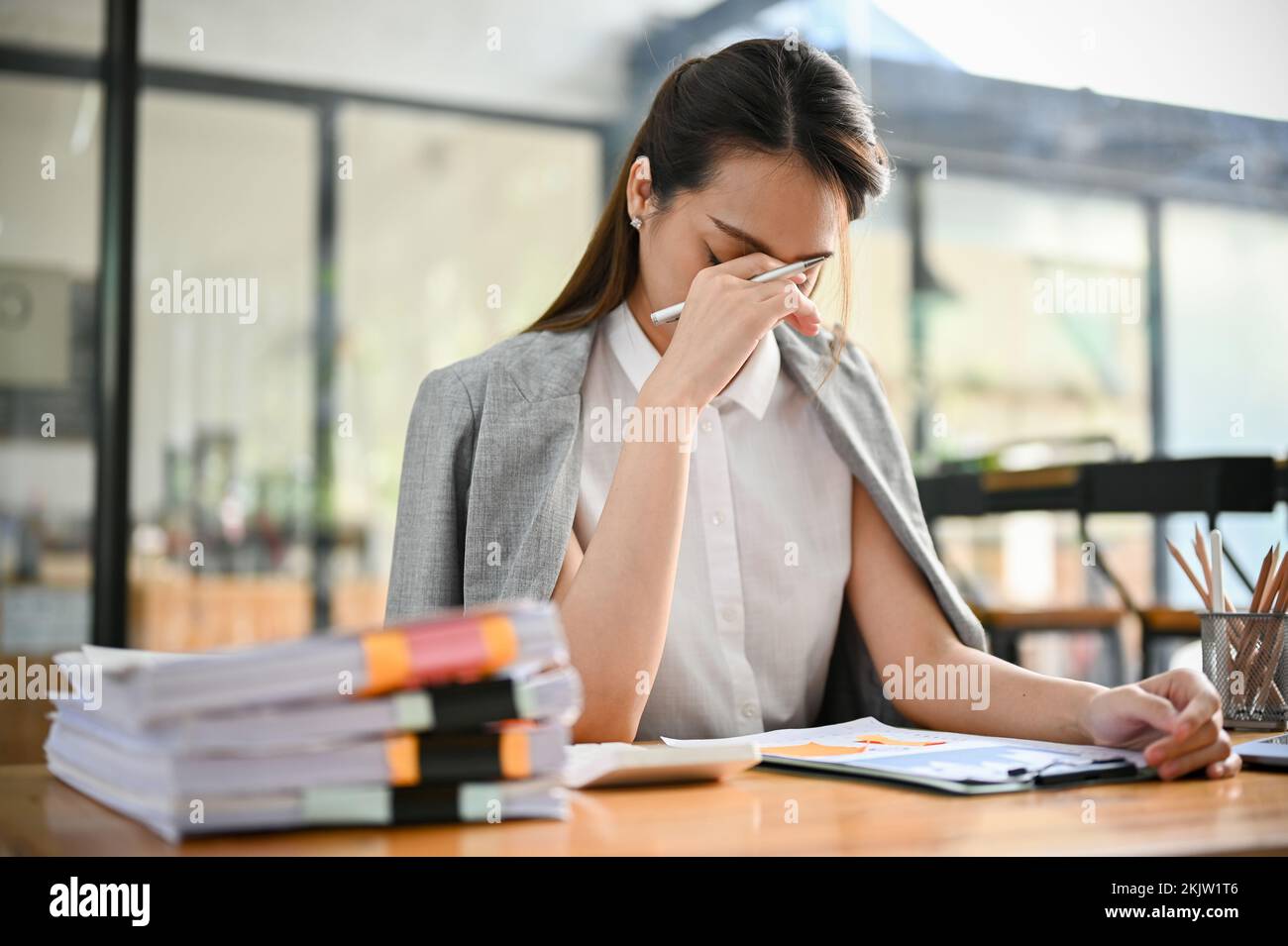 Stressed and upset millennial Asian businesswoman or female manager ...