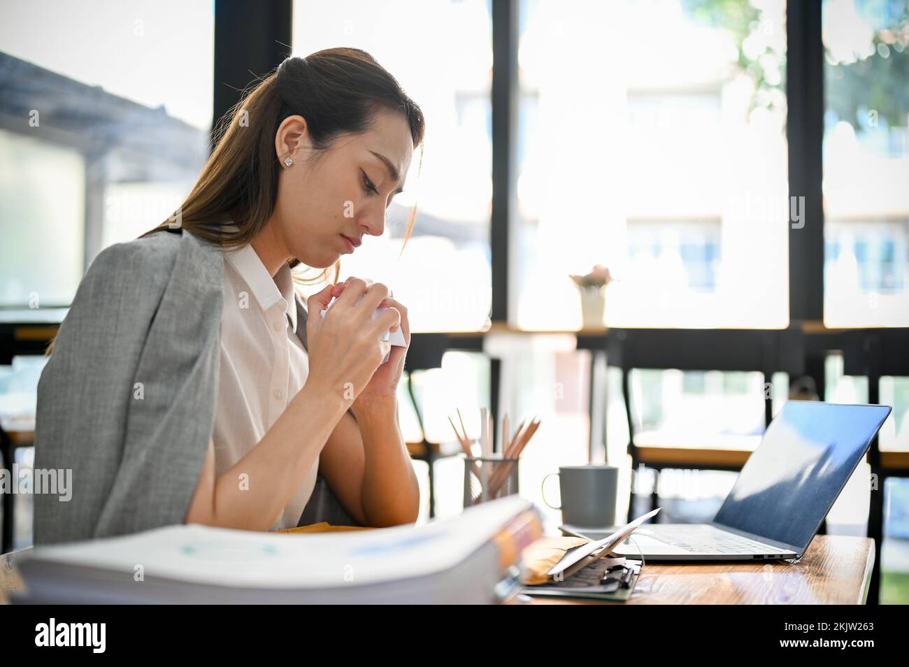 Sad and depressed millennial Asian businesswoman upset and dissatisfied ...