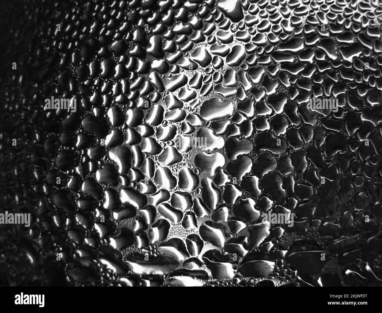 Glass with raindrops on dark tone background. Abstract wet texture with ...