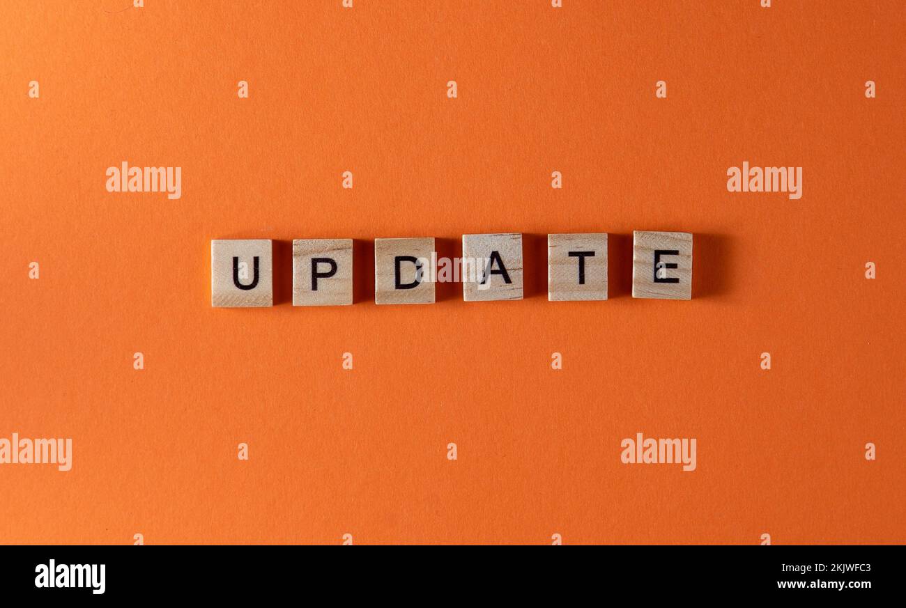 Update word phrase in wooden letters. Motivation and slogan. Orange ...