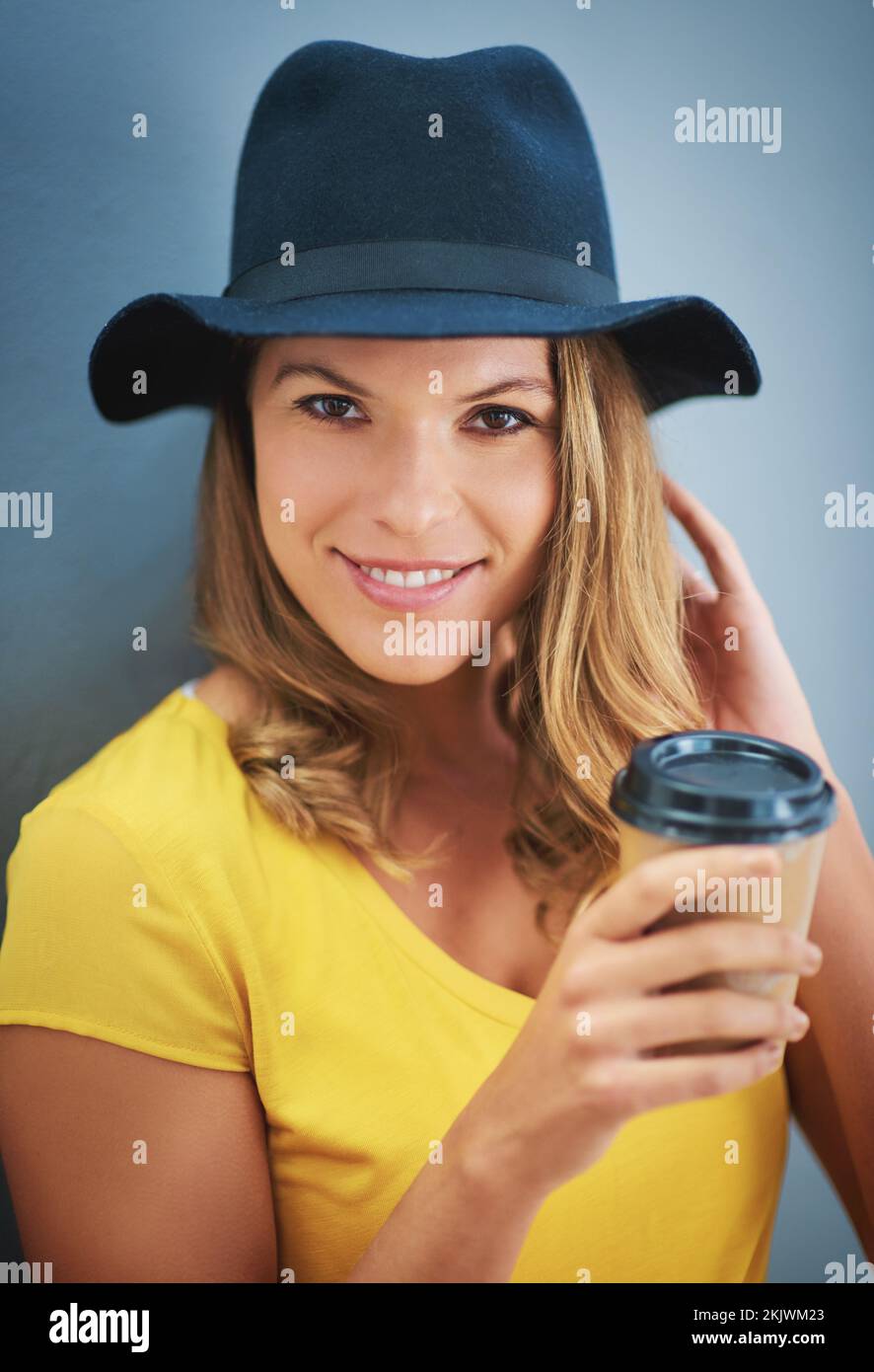 Portrait, coffee and fashion with a model woman in studio on a gray ...
