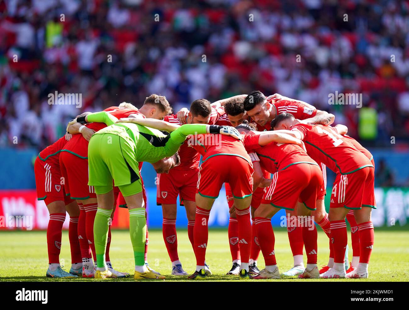 Wales players huddle together on the pitch ahead of the FIFA World Cup ...