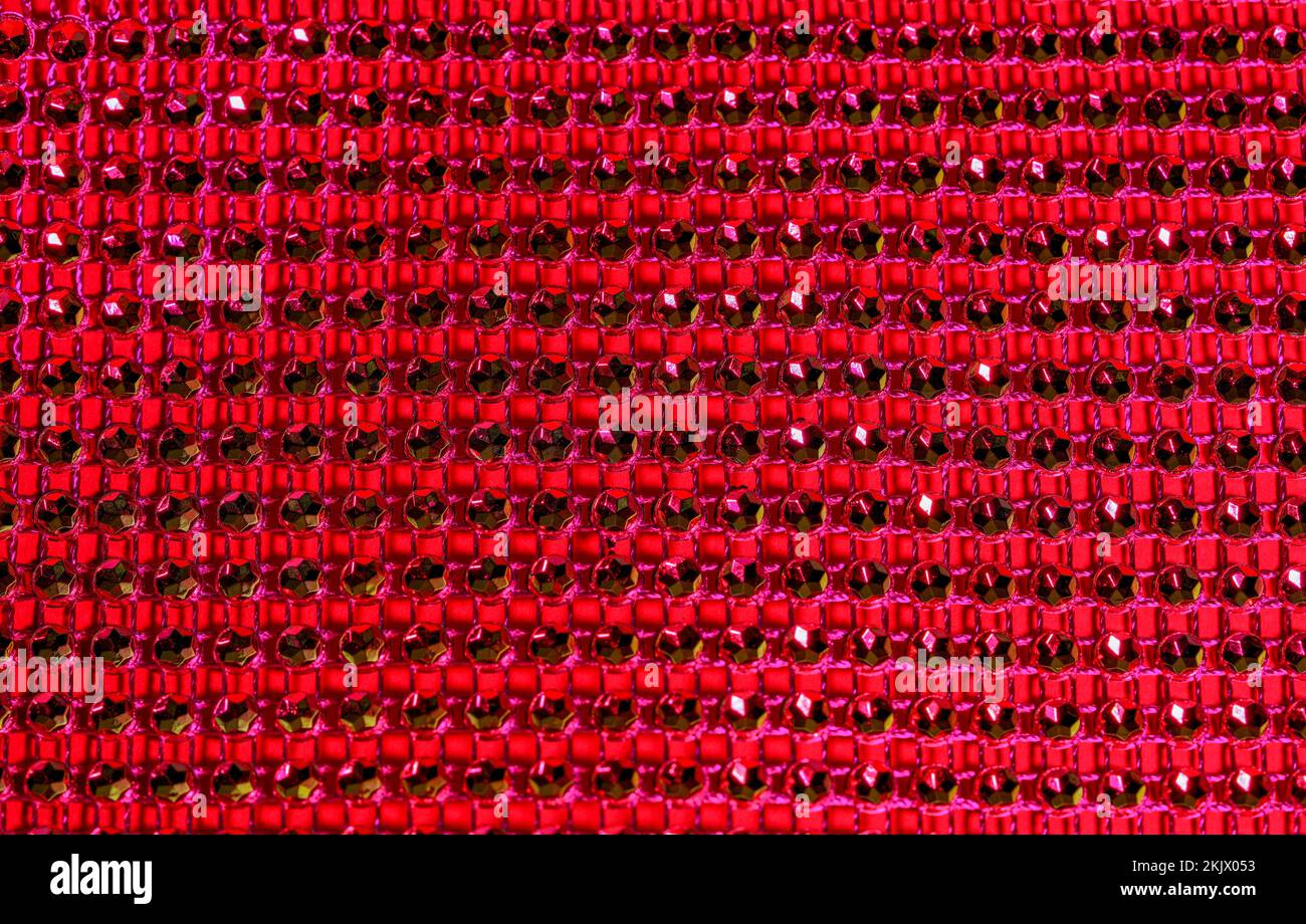 A close-up of red fabric with shiny rhinestones perfect for backgrounds ...