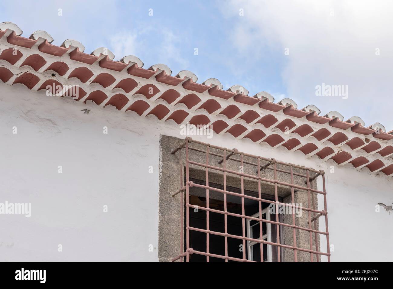 detail of traditional roof-tile cornice at old building, shot in bright ...