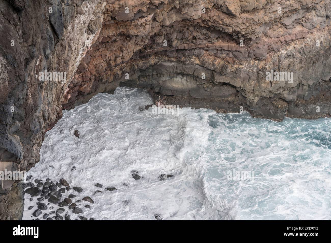 landscape with ocean waves froth and volcanic cliffs at Madeira island ...