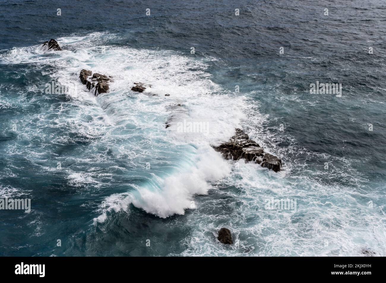 landscape with froth of ocean waves on volcanic cliffs at Madeira ...