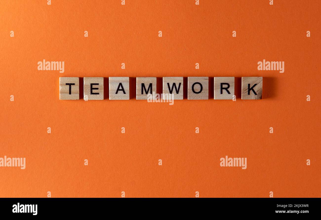 Teamwork word phrase in wooden letters. Motivation and slogan. Orange ...