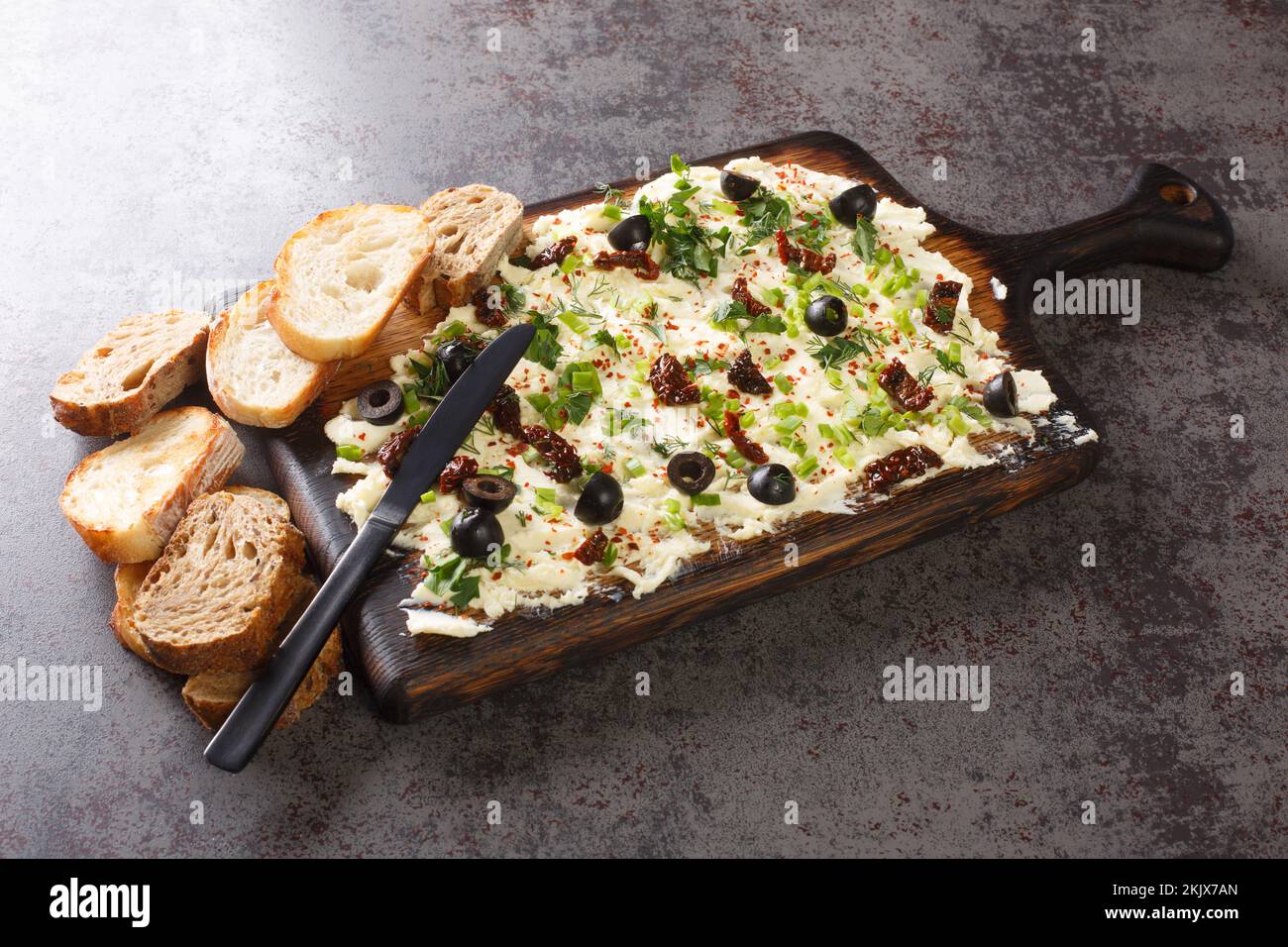 Homemade appetizer oil board with chili flakes, olives, sun dried ...