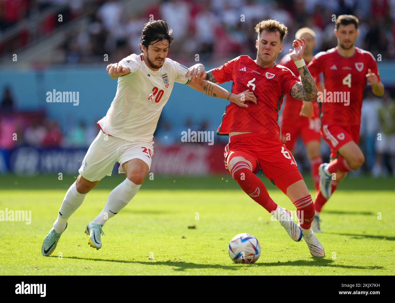Iran's Sardar Azmoun (left) and Wales' Joe Rodon battle for the ball ...