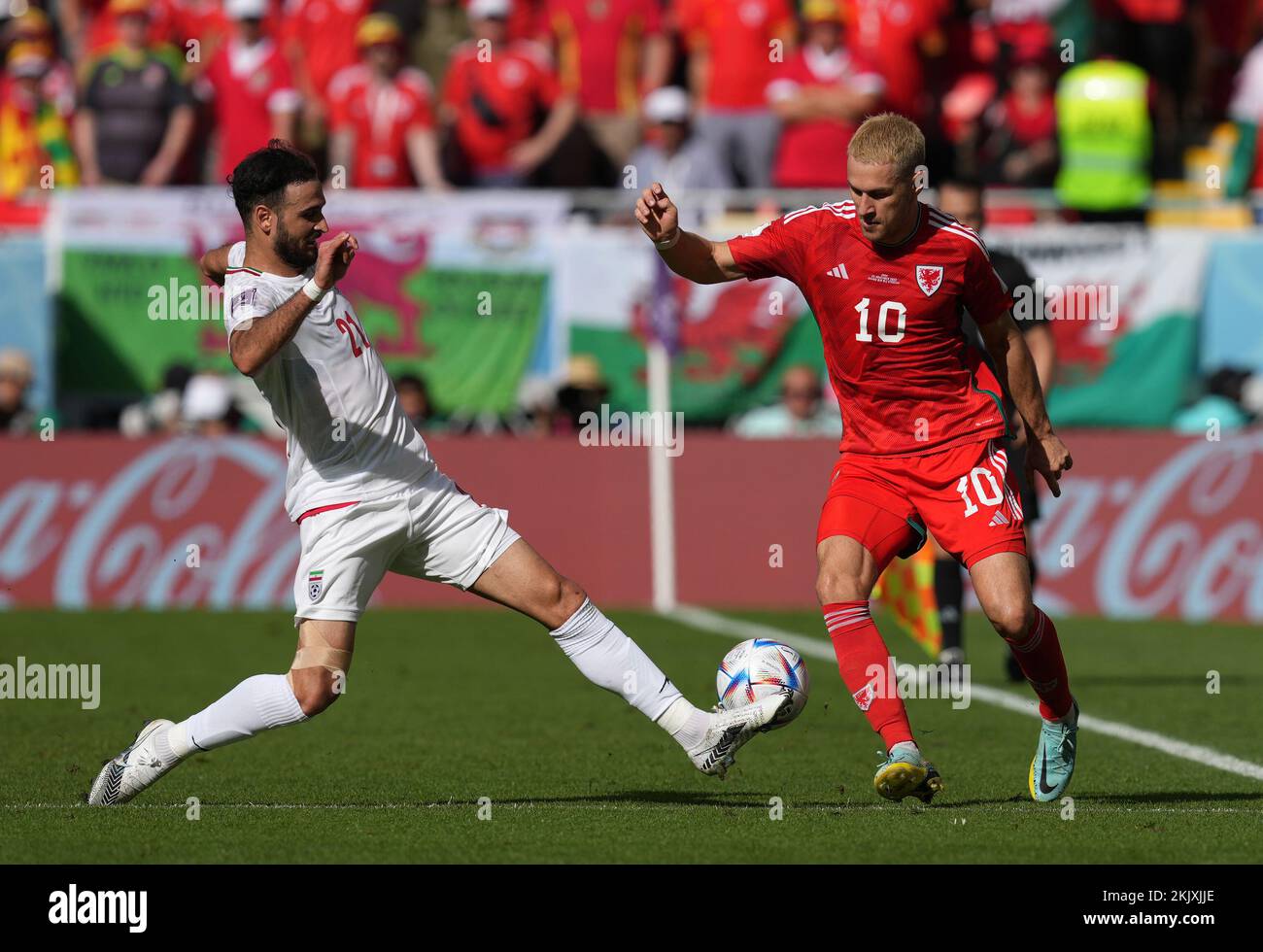Iran's Ahmad Noorollahi (left) and Wales' Aaron Ramsey battle for the ...
