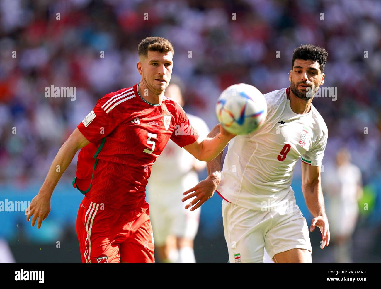 Wales' Chris Mepham (left) and Iran's Mehdi Taremi battle for the ball ...
