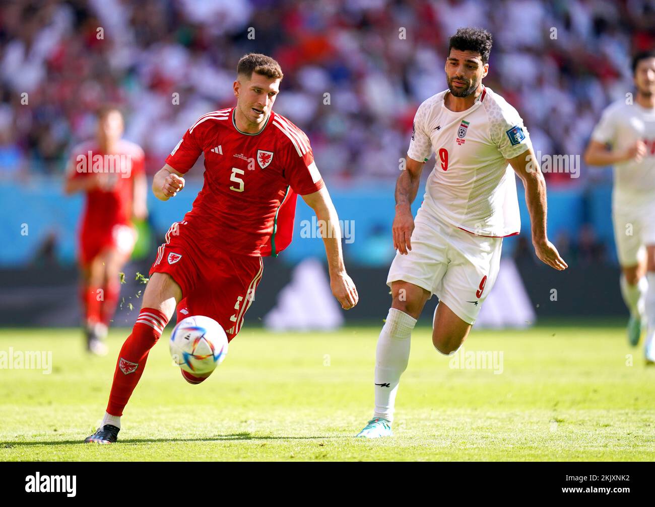 Wales' Chris Mepham (left) and Iran's Mehdi Taremi battle for the ball ...