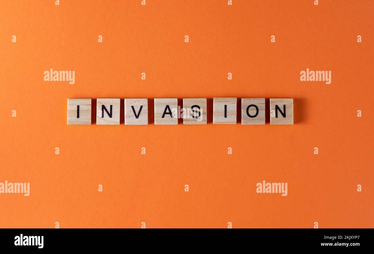 Invasion word phrase in wooden letters. Motivation and slogan. Orange ...