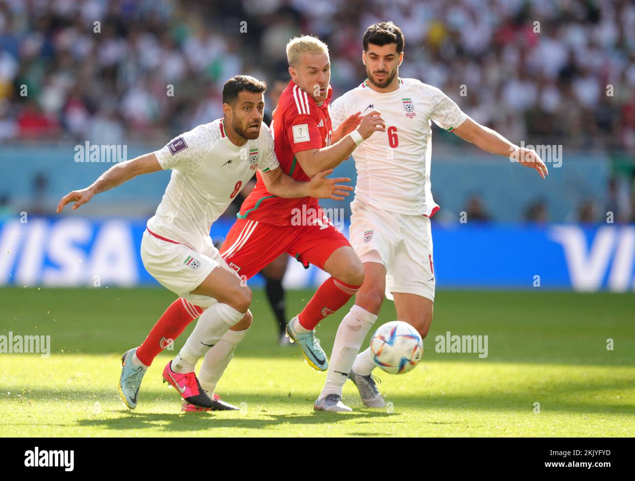 Iran's Morteza Pouraliganji (left) and Wales' Aaron Ramsey battle for ...