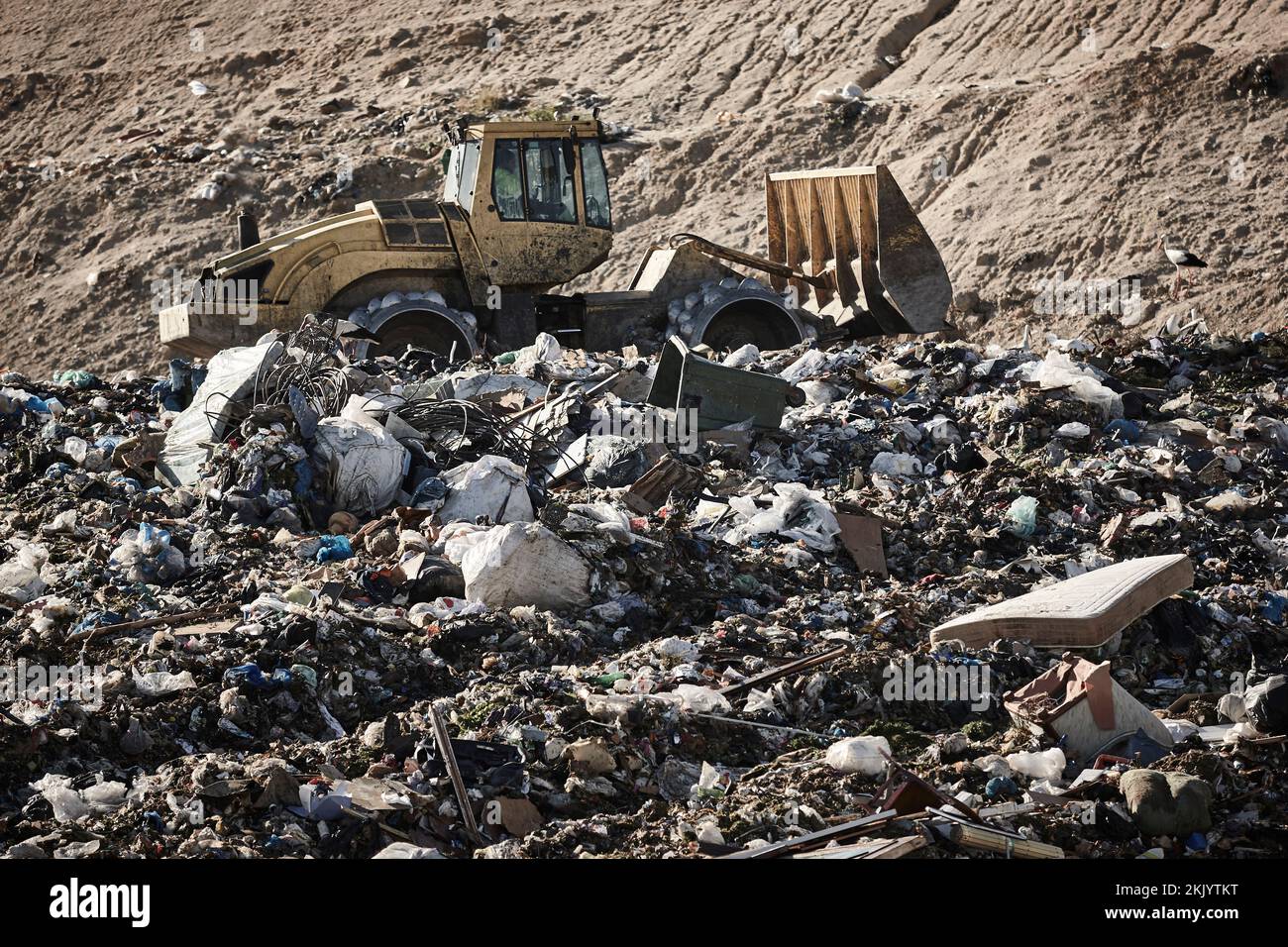 Heavy machinery shredding garbage in an open air landfill. Waste Stock ...