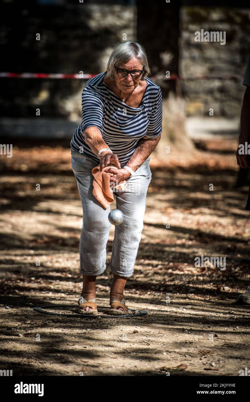 A player throws a ball, boule during a traditional french game of ...