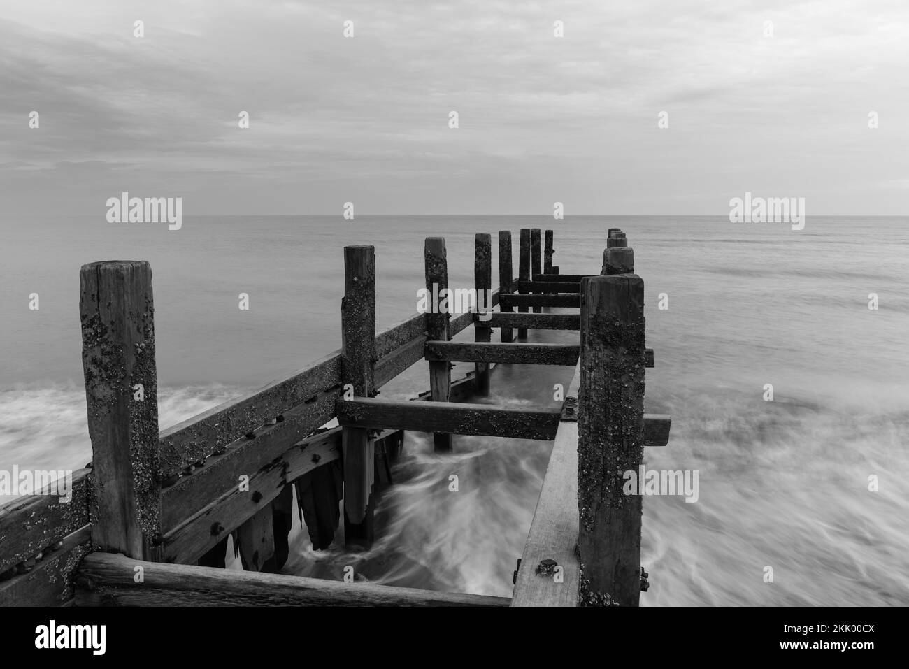 An afternoon monochrome shot of one of the old wooden sea defence ...