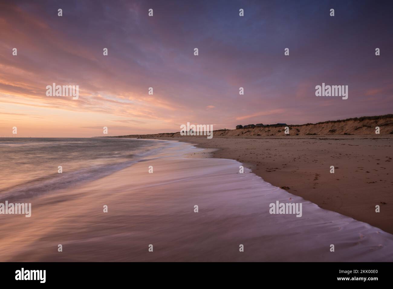 A sunrise dawn shot with colourful clouds, along the surf line at ...