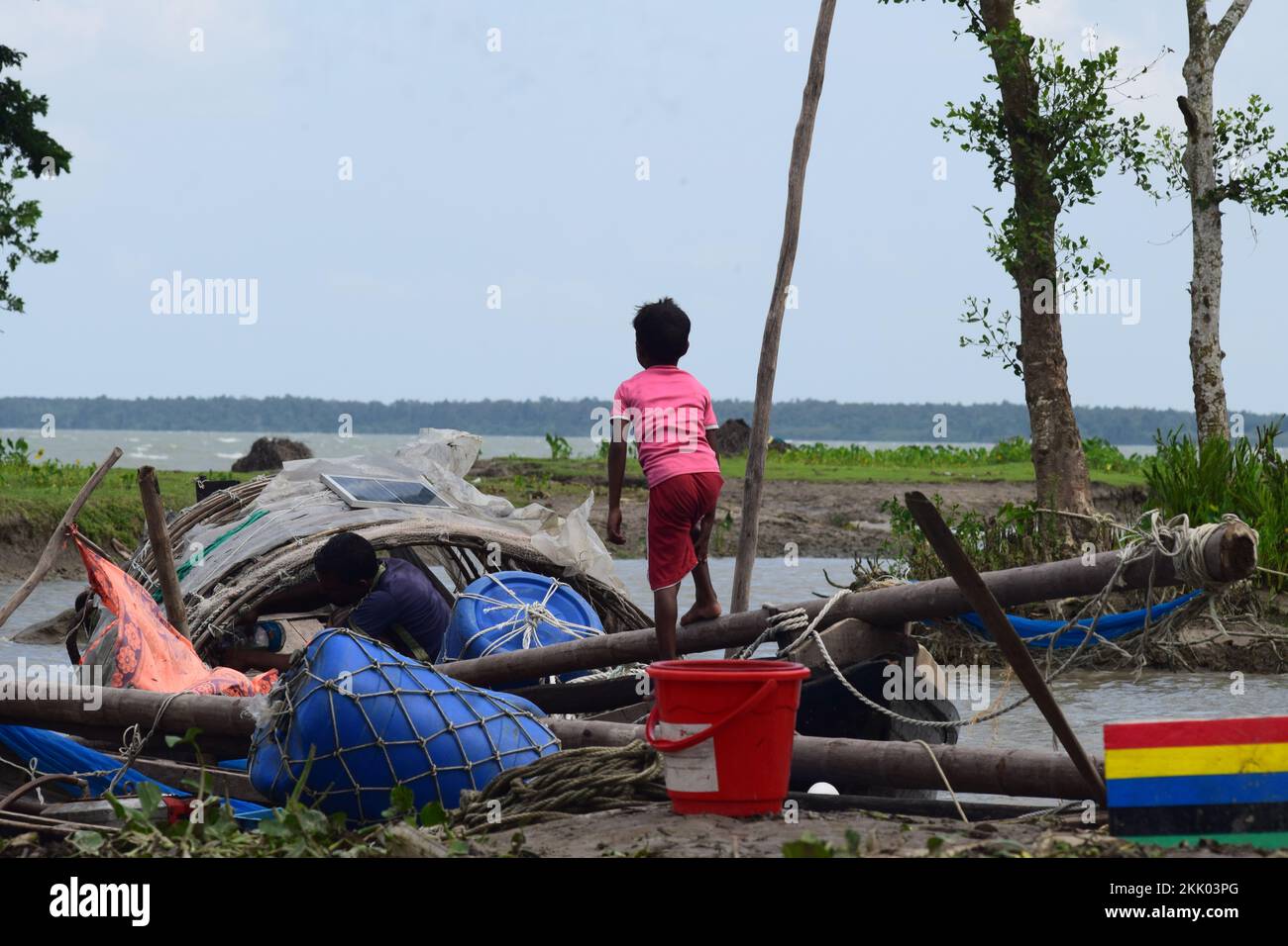 Coastal fisherman's kid bringing bucket to collect fish Stock Photo - Alamy
