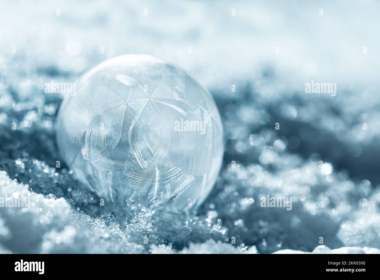 frozen bubble with bokeh background. Beautiful frosty patterns on ...