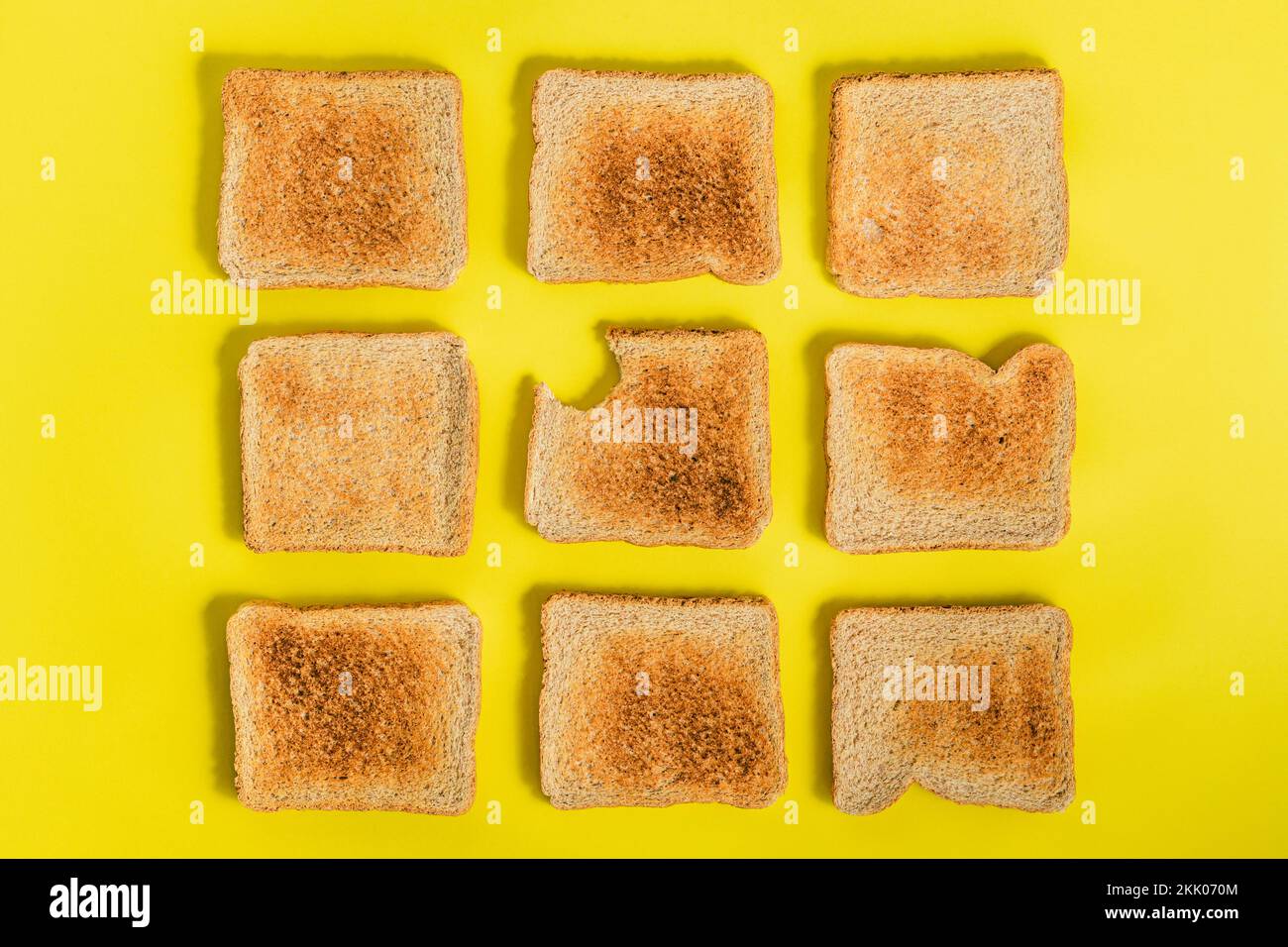 Top view of a pattern of various slices of toasted bread arranged on a ...