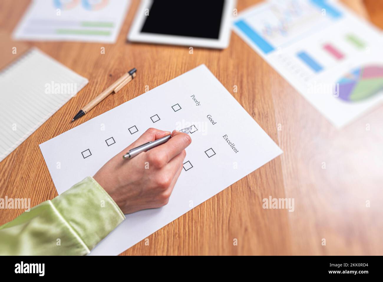 A woman's hand fills out a checklist or an exam test giving a mark of ...