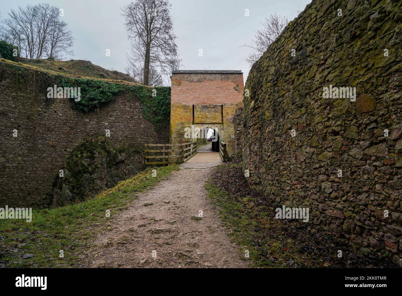 The walls covered in vegetation heading to the brick building Stock ...