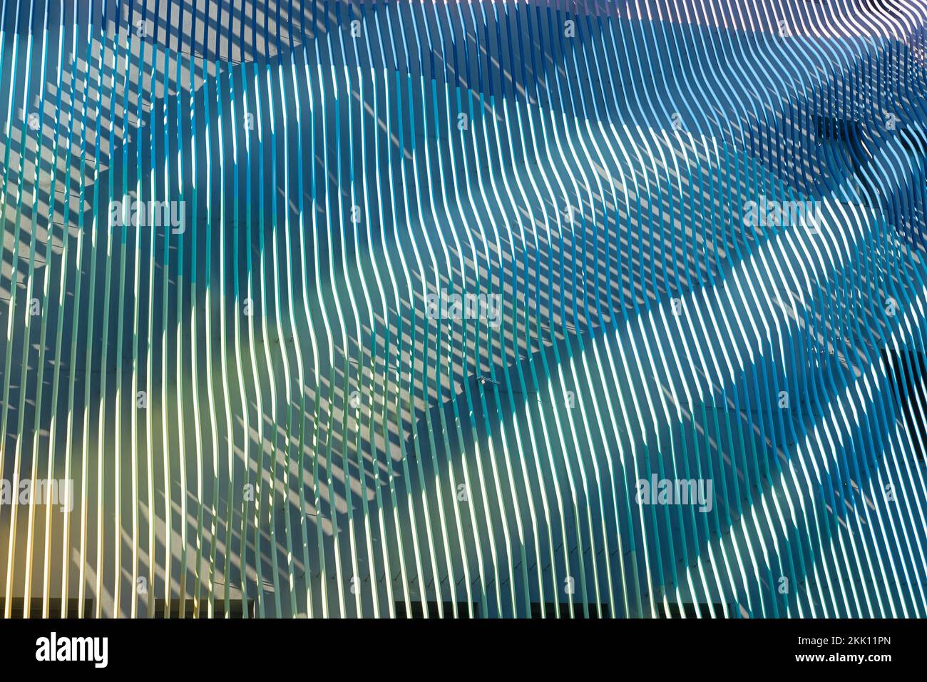 Abstract building wall design. Multicolored metal lines in the design ...