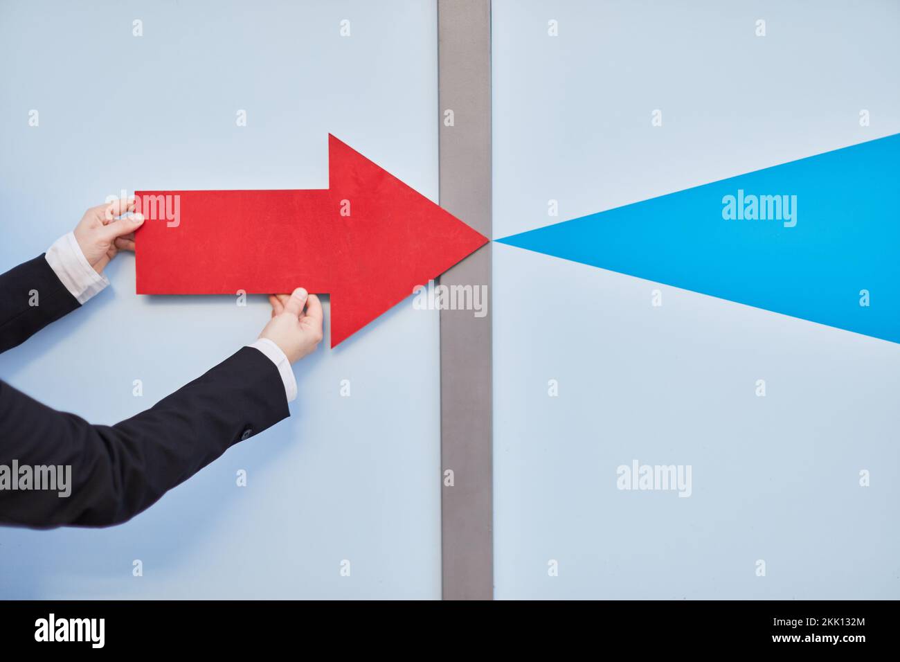 Hand holding red arrow sign meeting blue lines as communication concept ...
