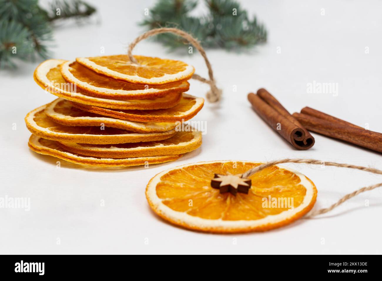 Dry orange slices on a string, cinnamon sticks and sprigs of spruce ...