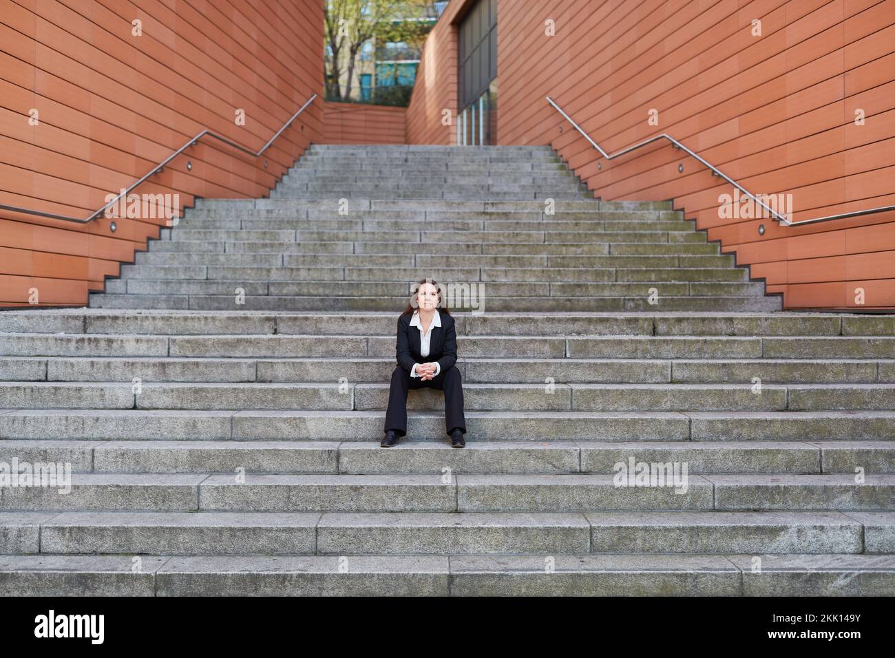 Woman sitting on urban staircase hi-res stock photography and images ...